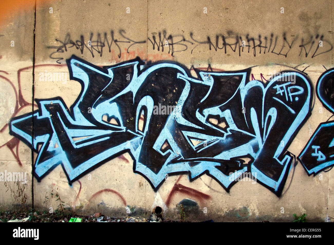 Graffiti art on a concert wall of a trashy abandoned street car road ...