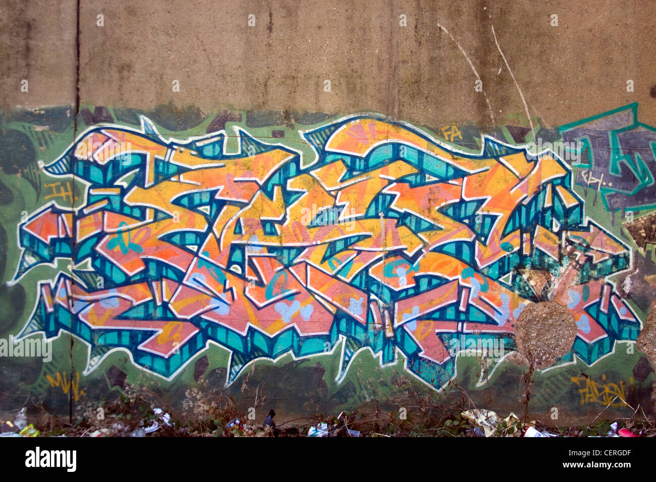 Graffiti art on a concert wall of a trashy abandoned street car road ...