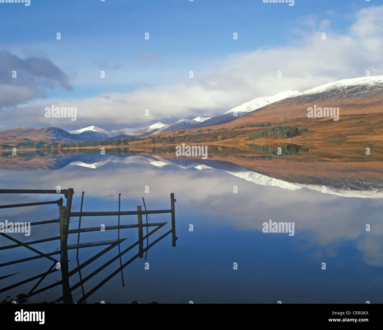 Snow capped mountains reflected in the still water of Loch Tulla Stock ...