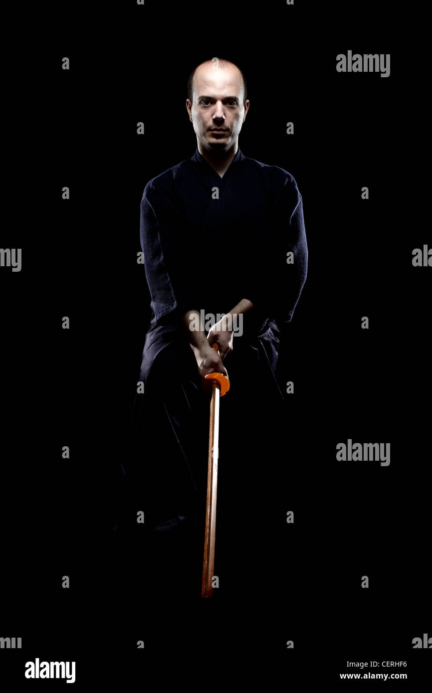 portrait of a kendo fighter with bokken, against black backgroung Stock ...