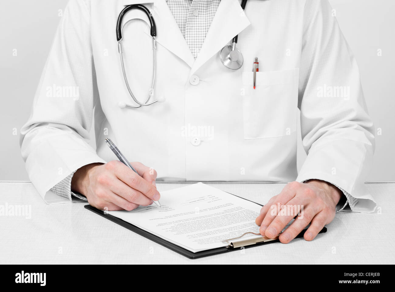 Doctor with stethoscope and clipboard writing something with pen Stock ...