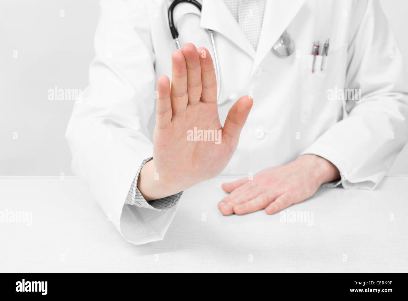 Doctor with stethoscope saying with hand gesture "stop Stock Photo - Alamy