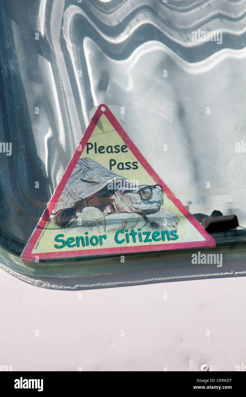 Please pass senior citizens sign on an old caravan Stock Photo - Alamy