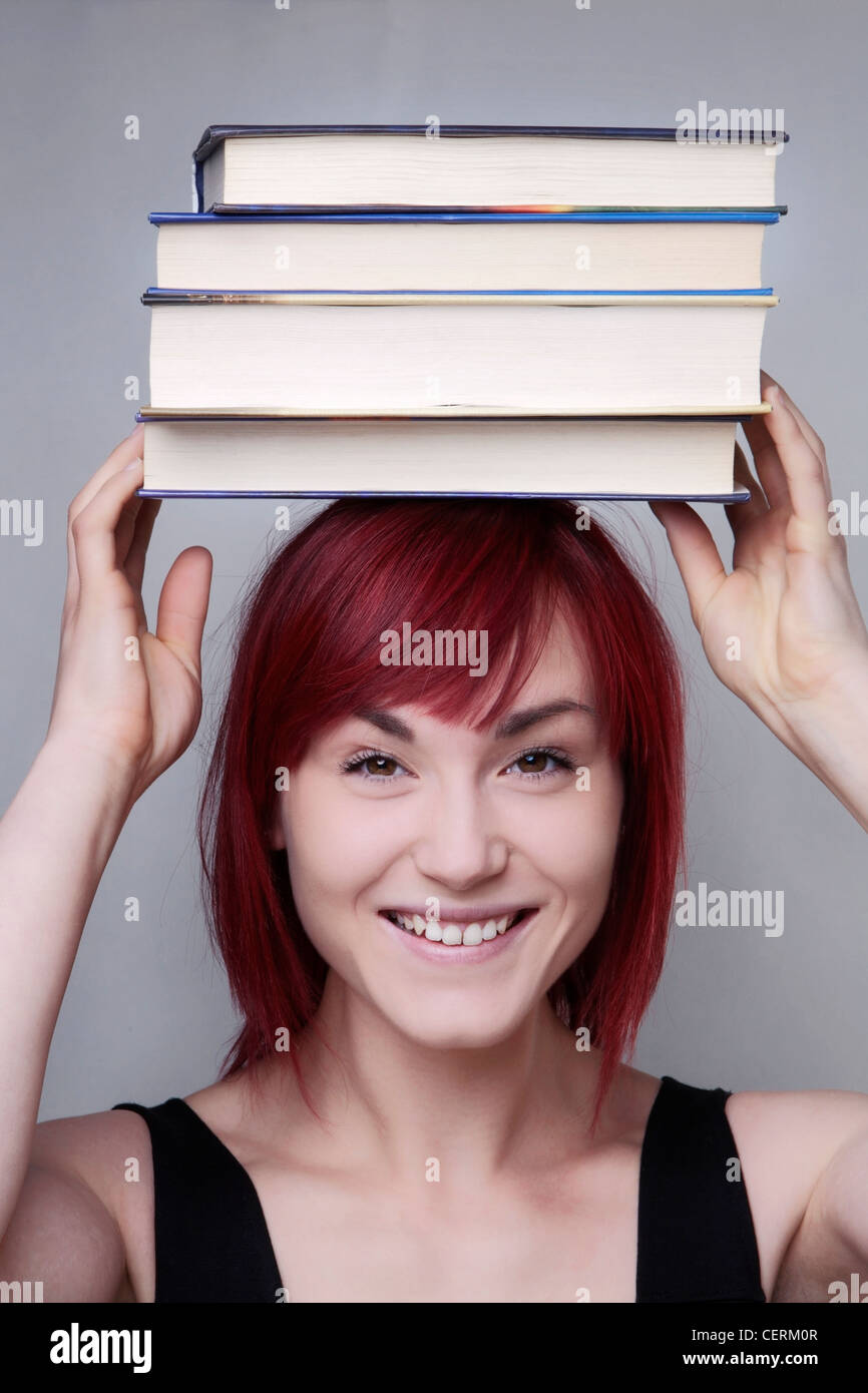 woman with books on top of her head Stock Photo - Alamy