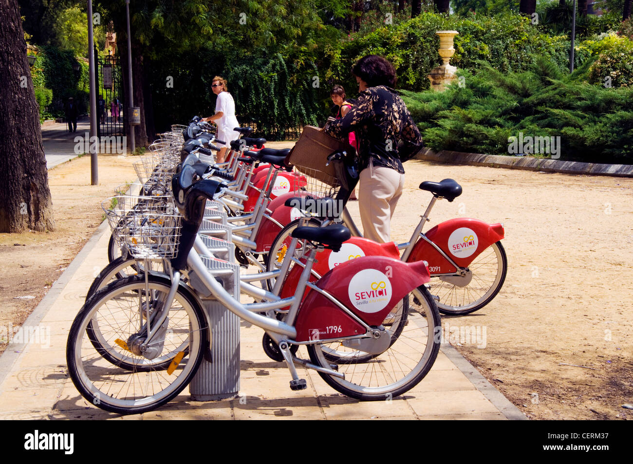 Women using the Sevici Sevilla a turitmo bicycle hire rental service ...