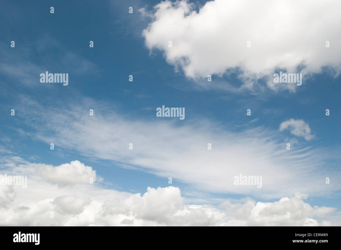 Blue sky with fluffy white clouds Stock Photo - Alamy