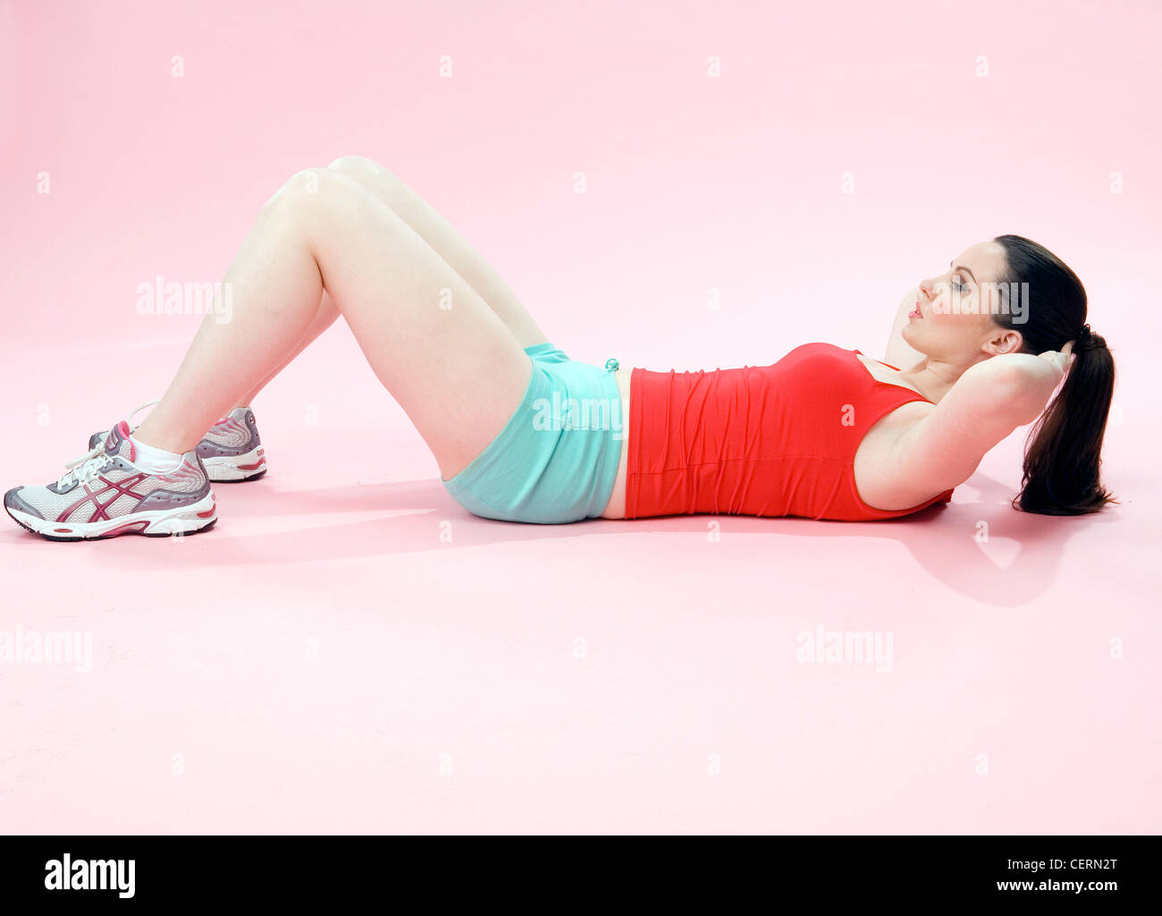 Female lying down knees raised hi-res stock photography and images - Alamy