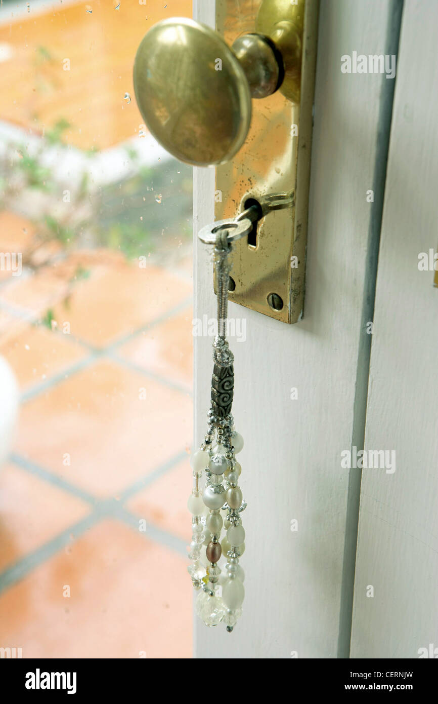 Beaded tassle used as a keyholder, key in door Stock Photo - Alamy