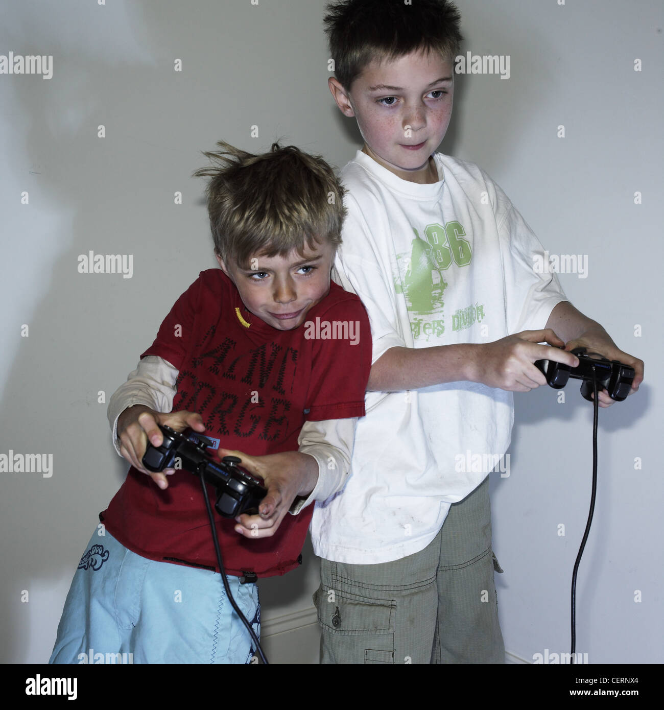 Two male children playing computer games Stock Photo - Alamy