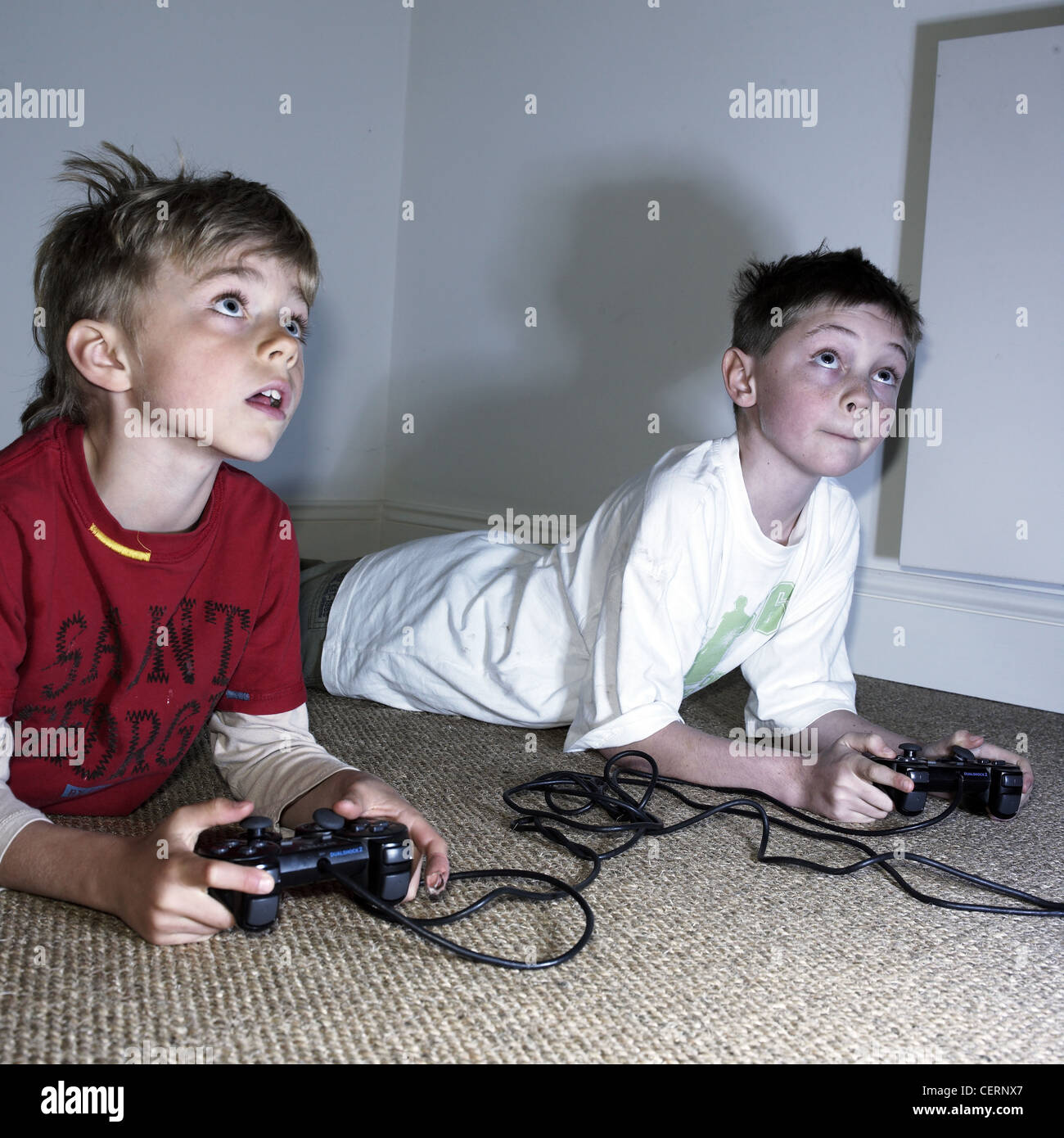 Two male children playing computer games Stock Photo - Alamy
