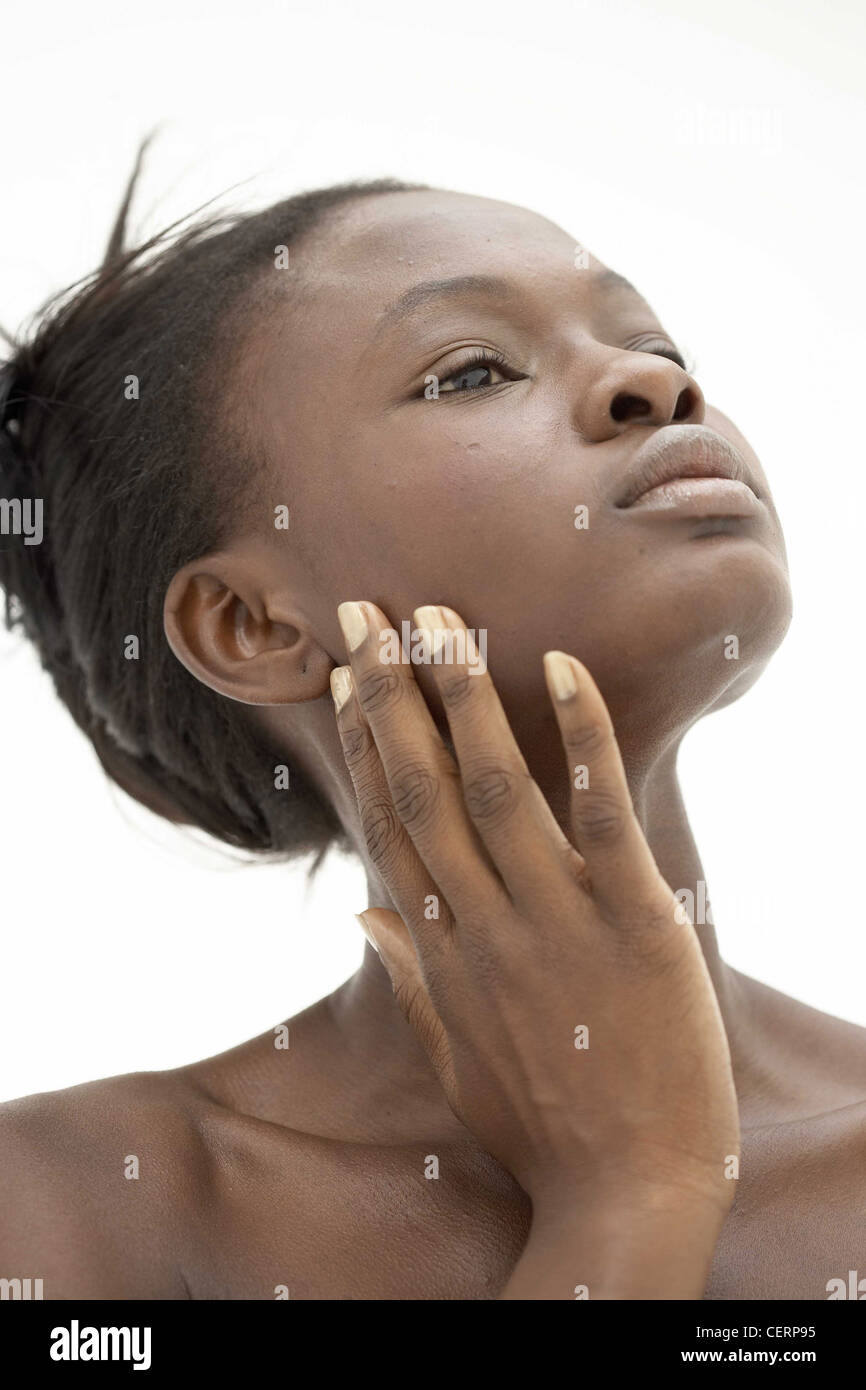 Female with hand touching face Stock Photo - Alamy