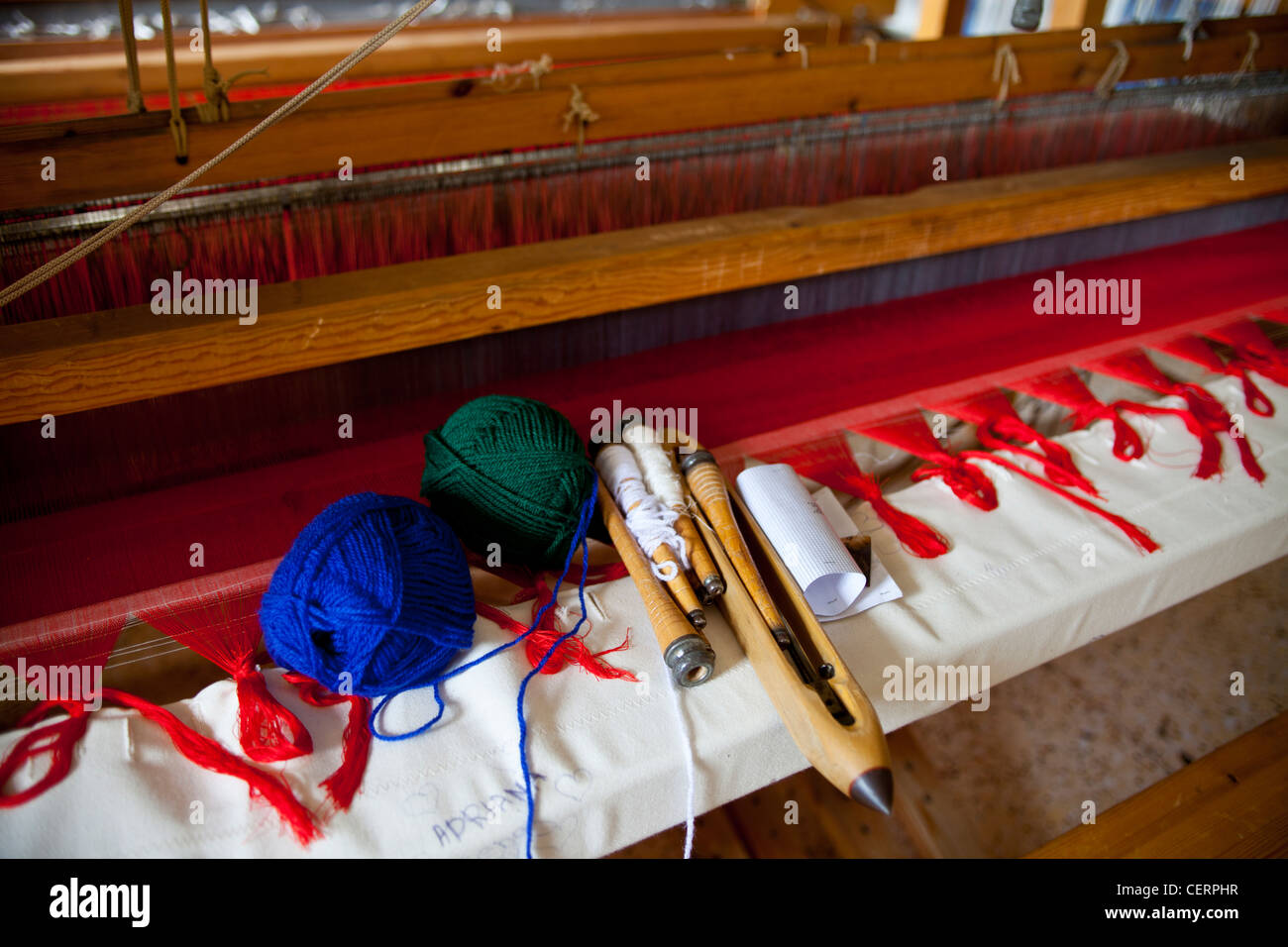 Photograph of an old traditional loom with colorful cotton threads and ...