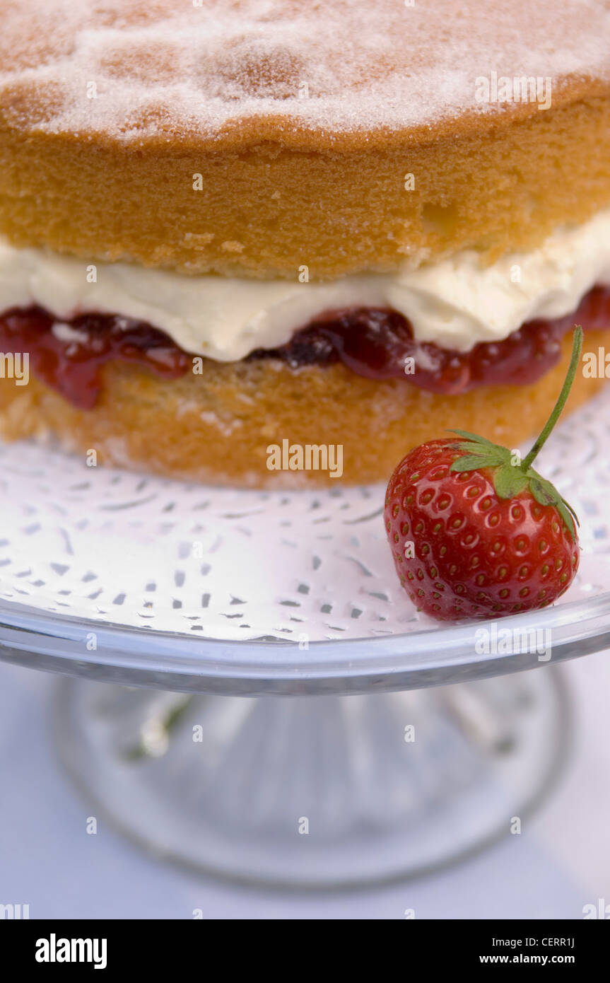 An English cream tea Victoria sponge cake with strawberry jam and cream ...