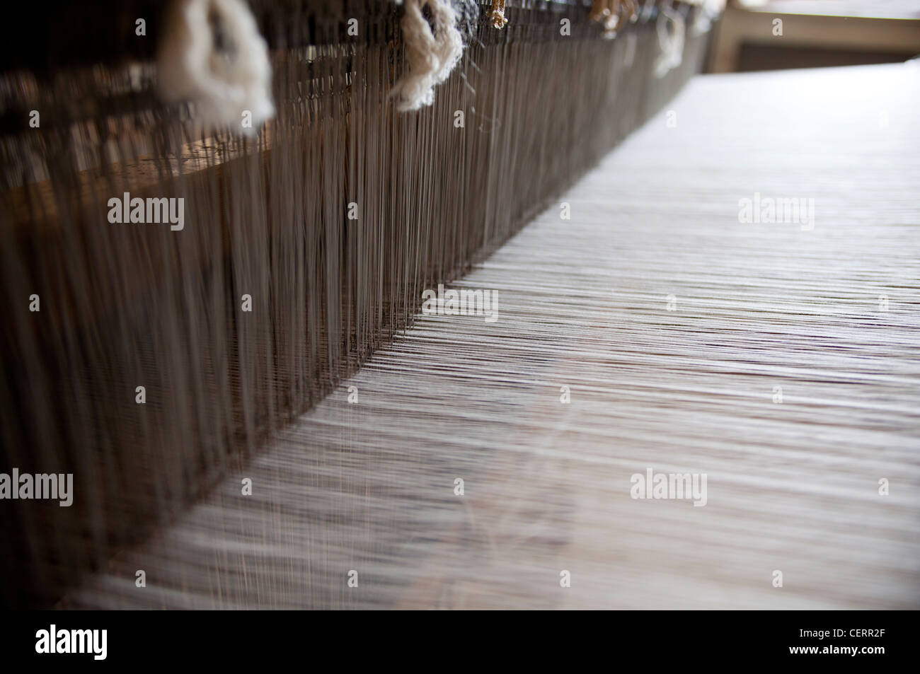 Close up photograph of an old traditional loom with cotton lined ...