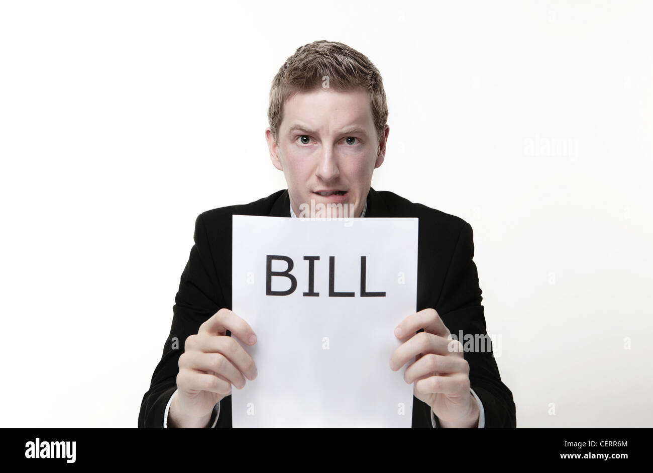 man in a suit sat at a desk look at a piece of paper with the words ...