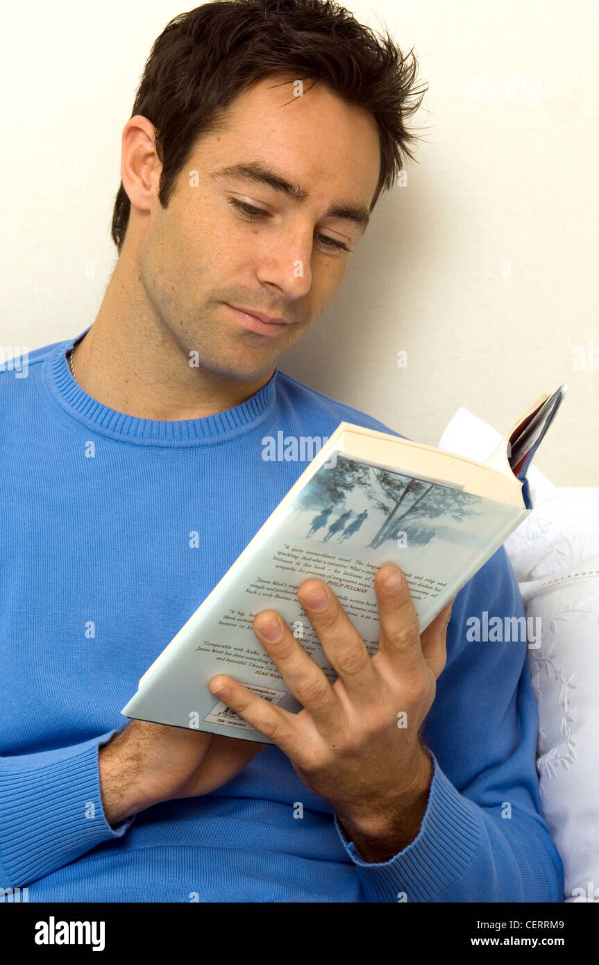 Male reading a book Stock Photo - Alamy