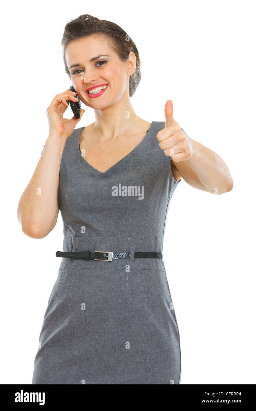 Business woman speaking cellphone and showing thumbs up Stock Photo - Alamy