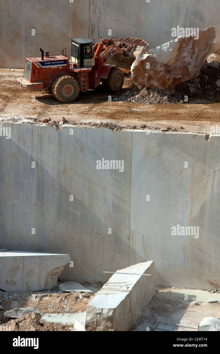 An excavator in a marble quarry in Sardinia Stock Photo - Alamy