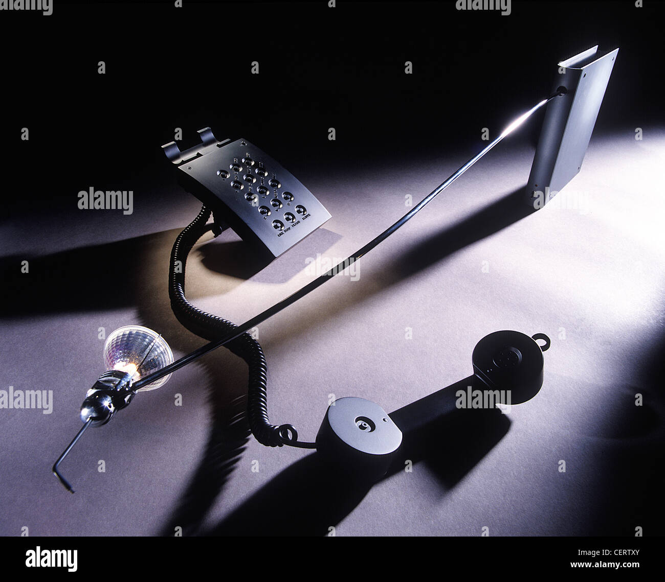 style telephone with an unusual desk light , lighting the underside of ...