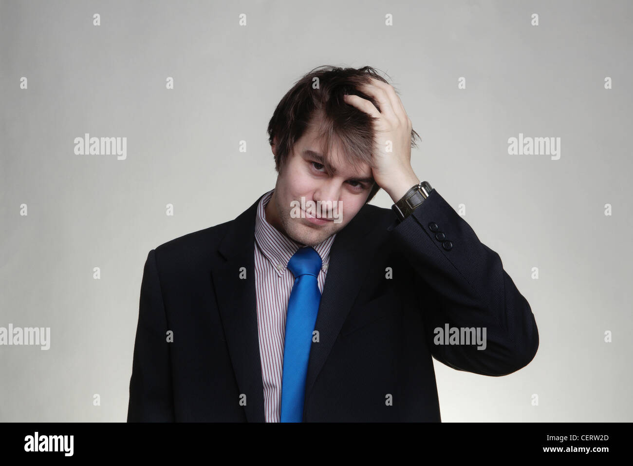 busniessman scratching his head Stock Photo - Alamy