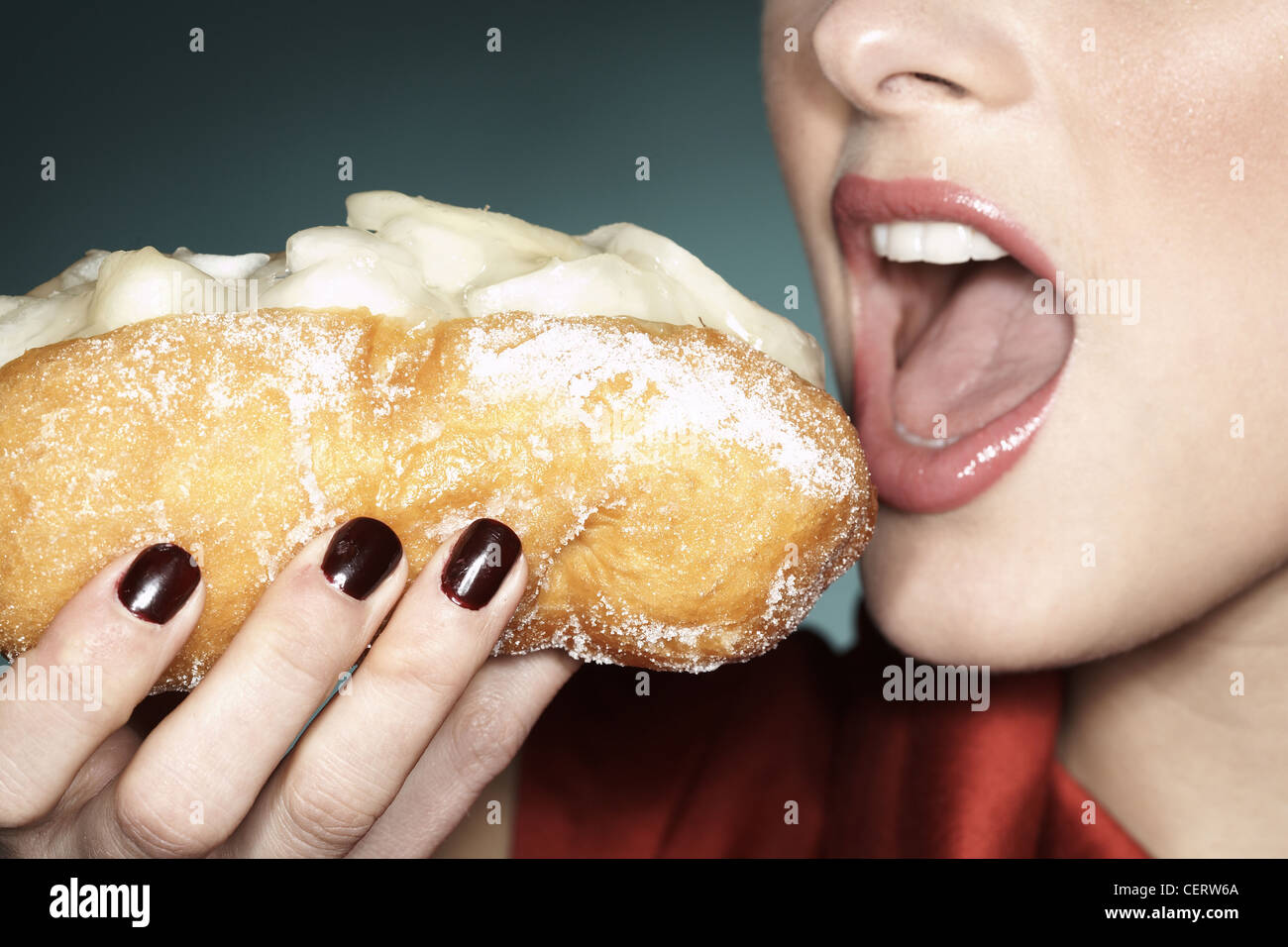 Female biting into a apple filled sugar coated bun Stock Photo - Alamy