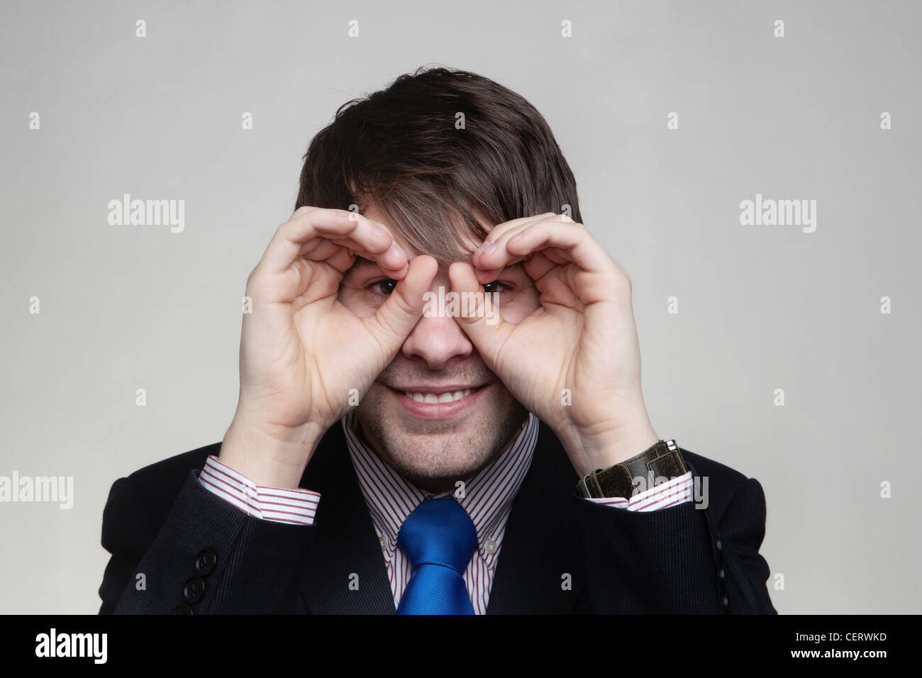 business man making binocular shape hands around eyes eyes Stock Photo ...