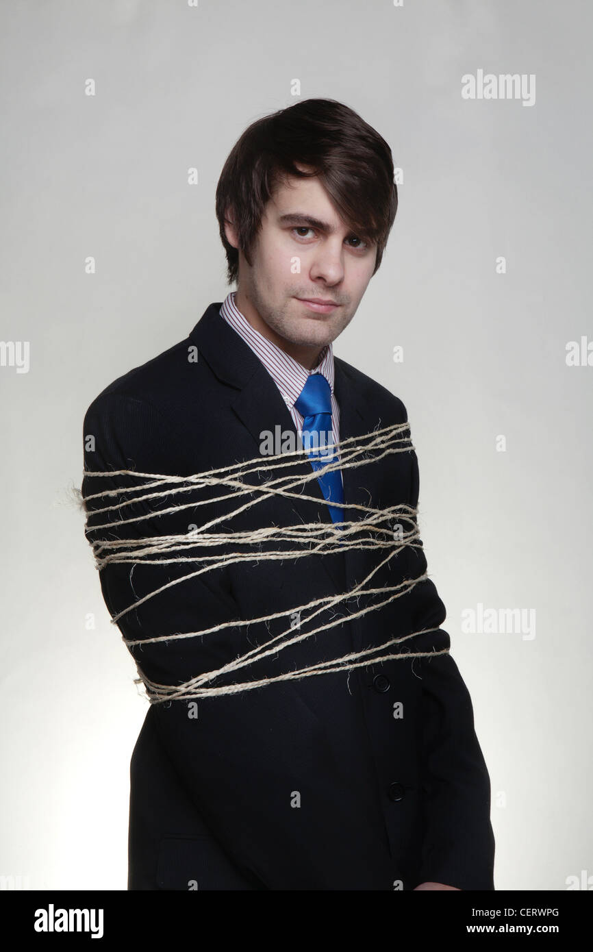 businessman tie up with string around his body Stock Photo - Alamy