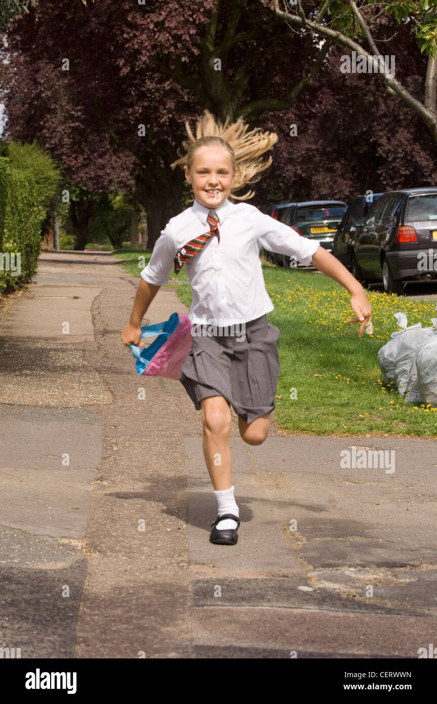 Young Female running down the pavement Stock Photo - Alamy