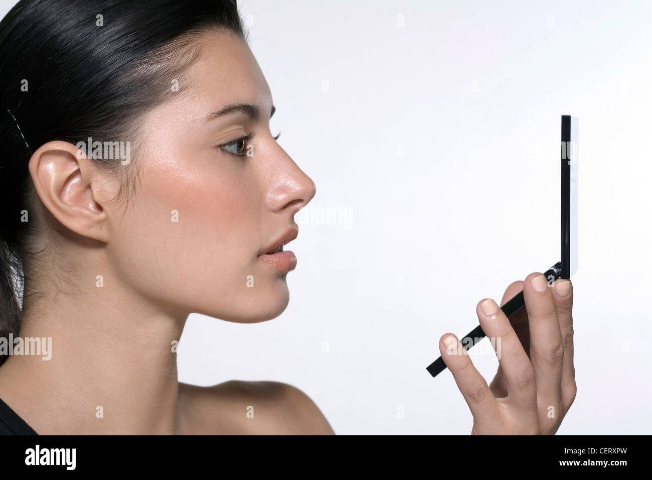 Female looking in a compact mirror Stock Photo - Alamy