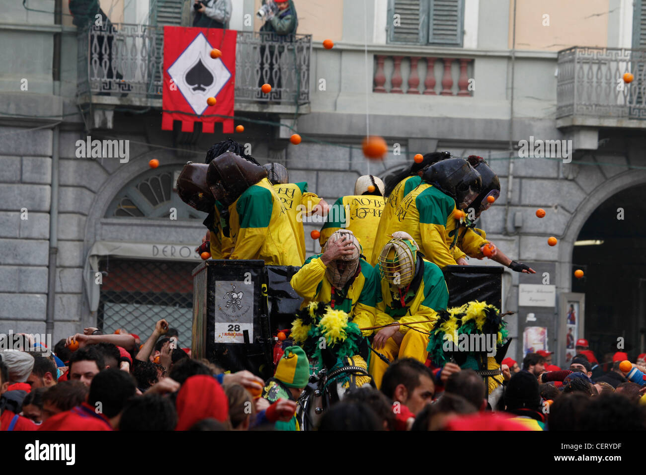 Crowds throwing oranges at the carriage during Ivrea Carnival's "Battle ...