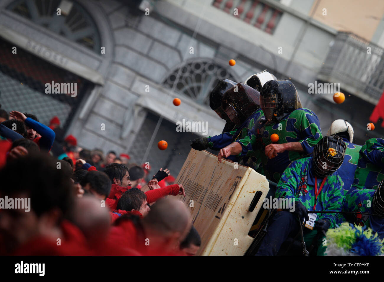 Crowds throwing oranges at the carriage during Ivrea Carnival's "Battle ...