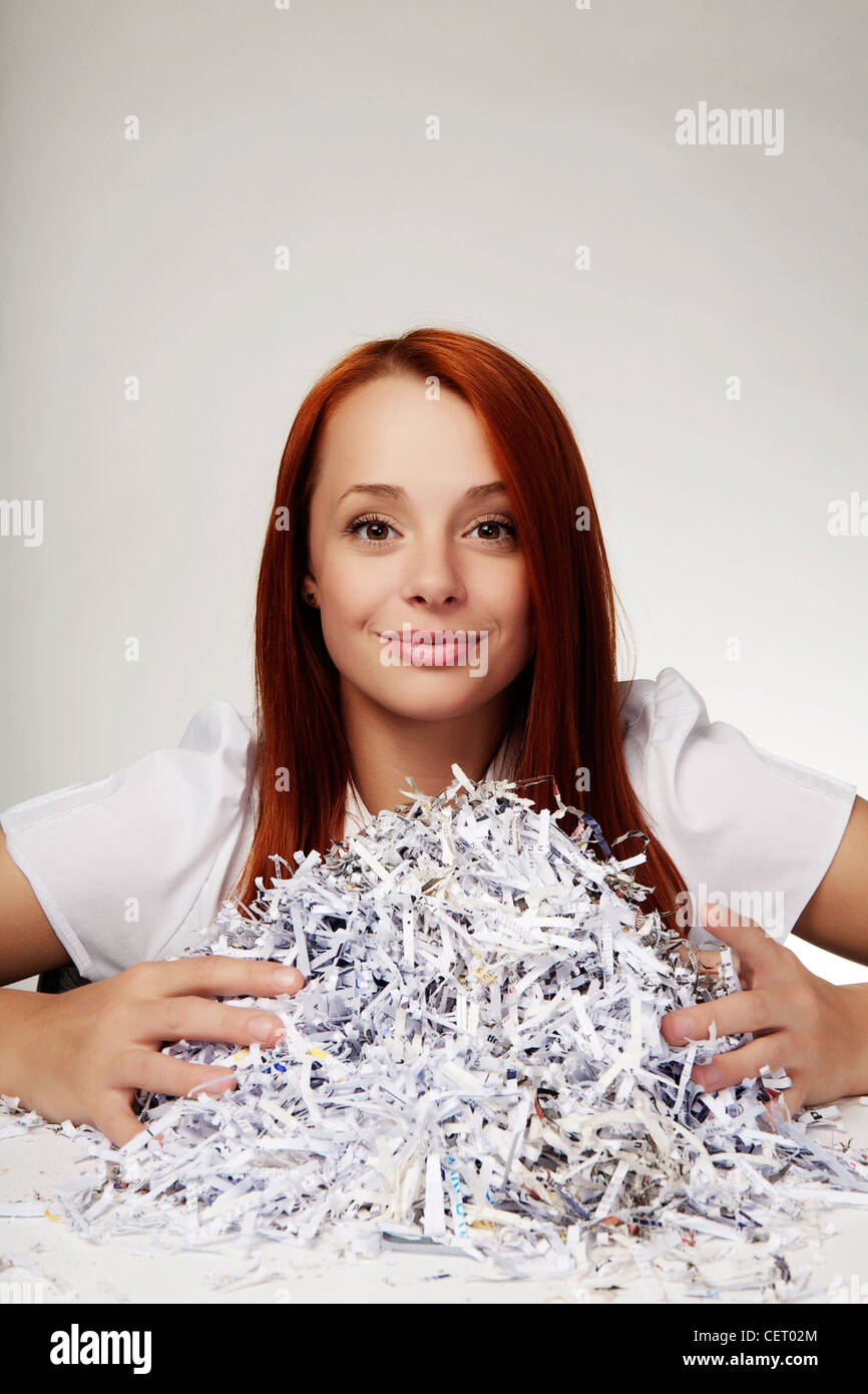 woman with a pile of shredded paper in front of her on her desk Stock ...