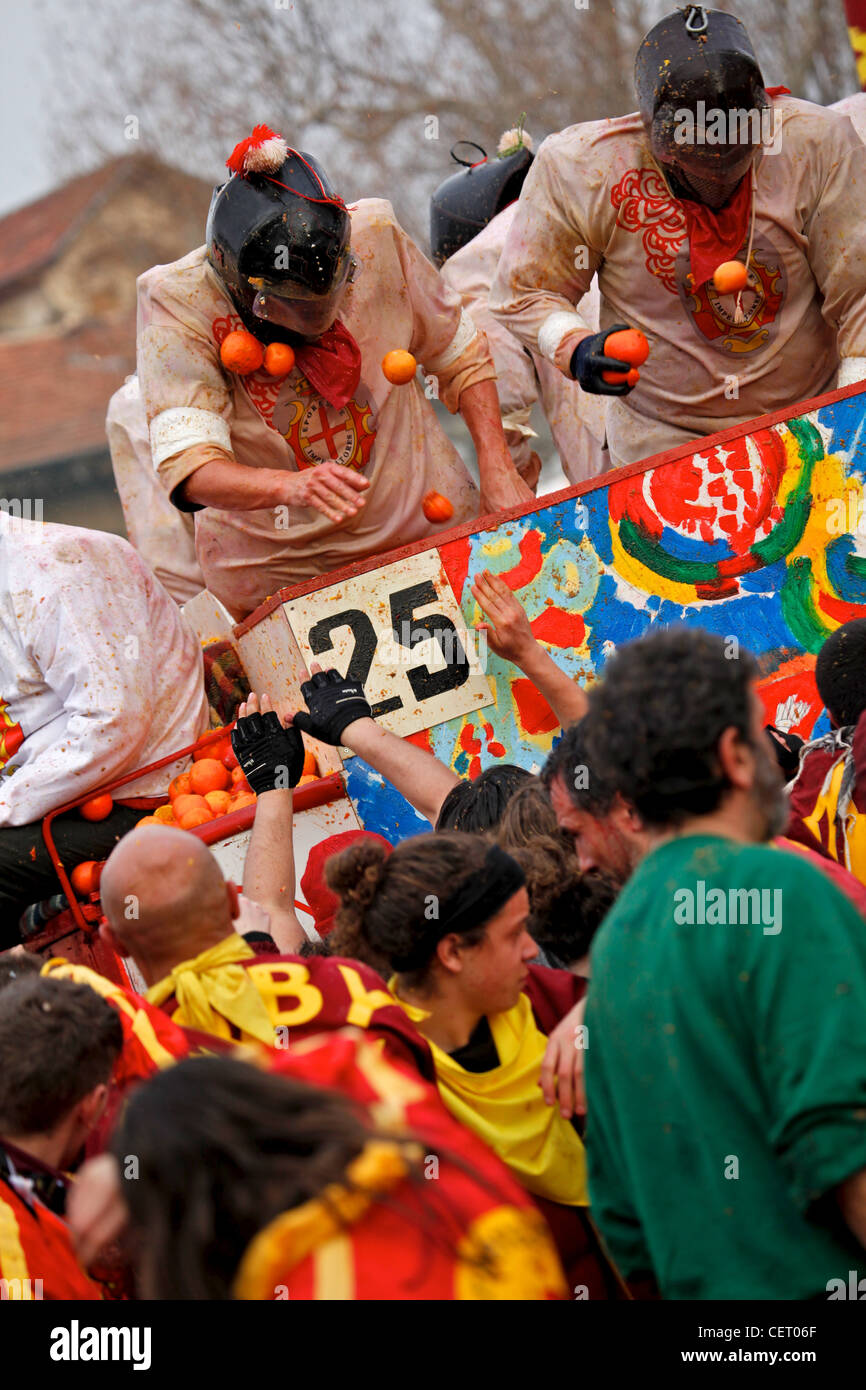 A glimpse of orange throwing action at Ivrea Carnival Stock Photo - Alamy