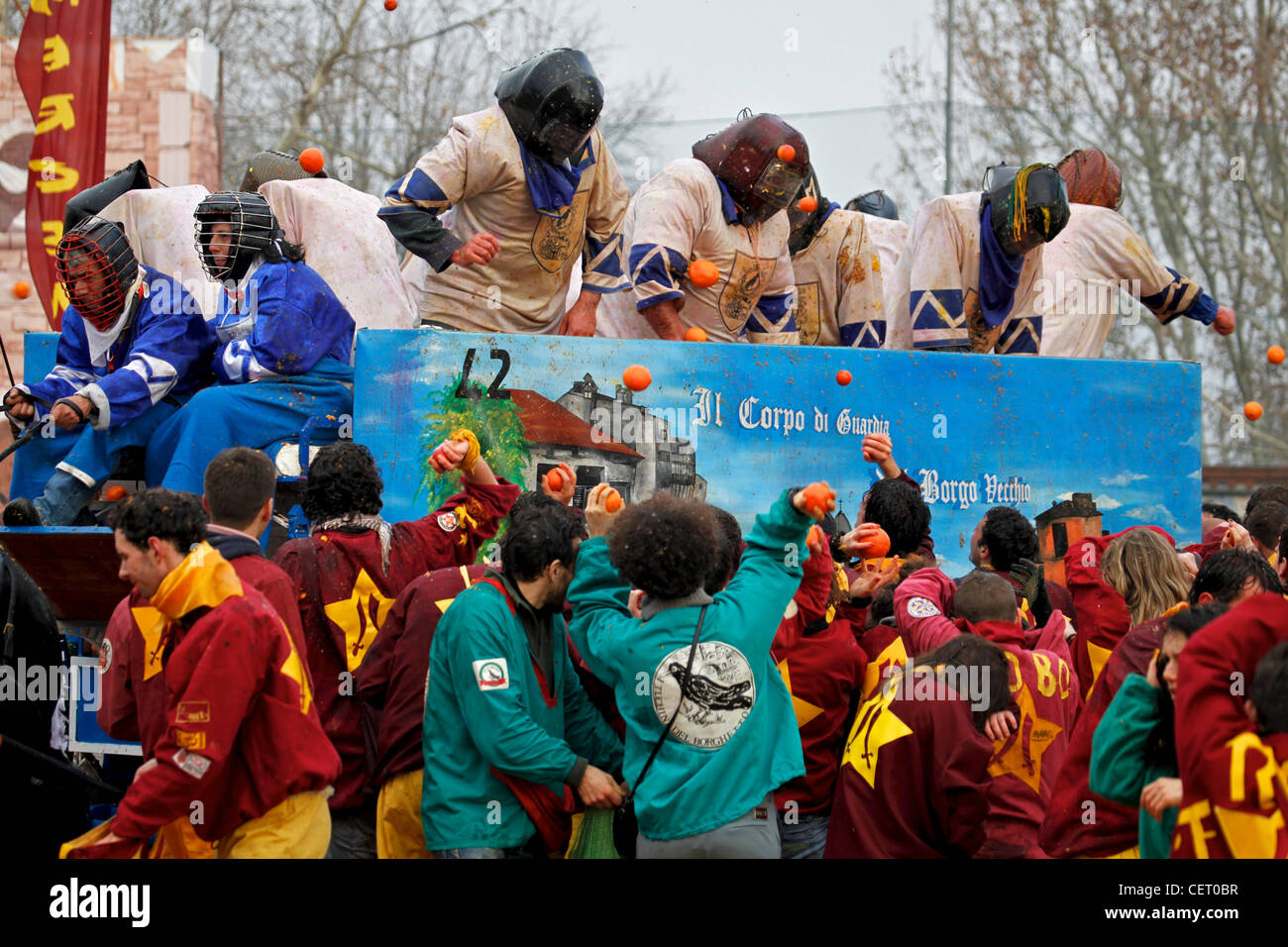 A glimpse of orange throwing action at Ivrea Carnival Stock Photo - Alamy