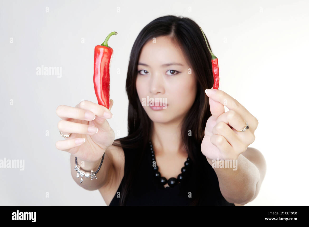 picture of lovely woman with a hot fresh chilli Stock Photo - Alamy