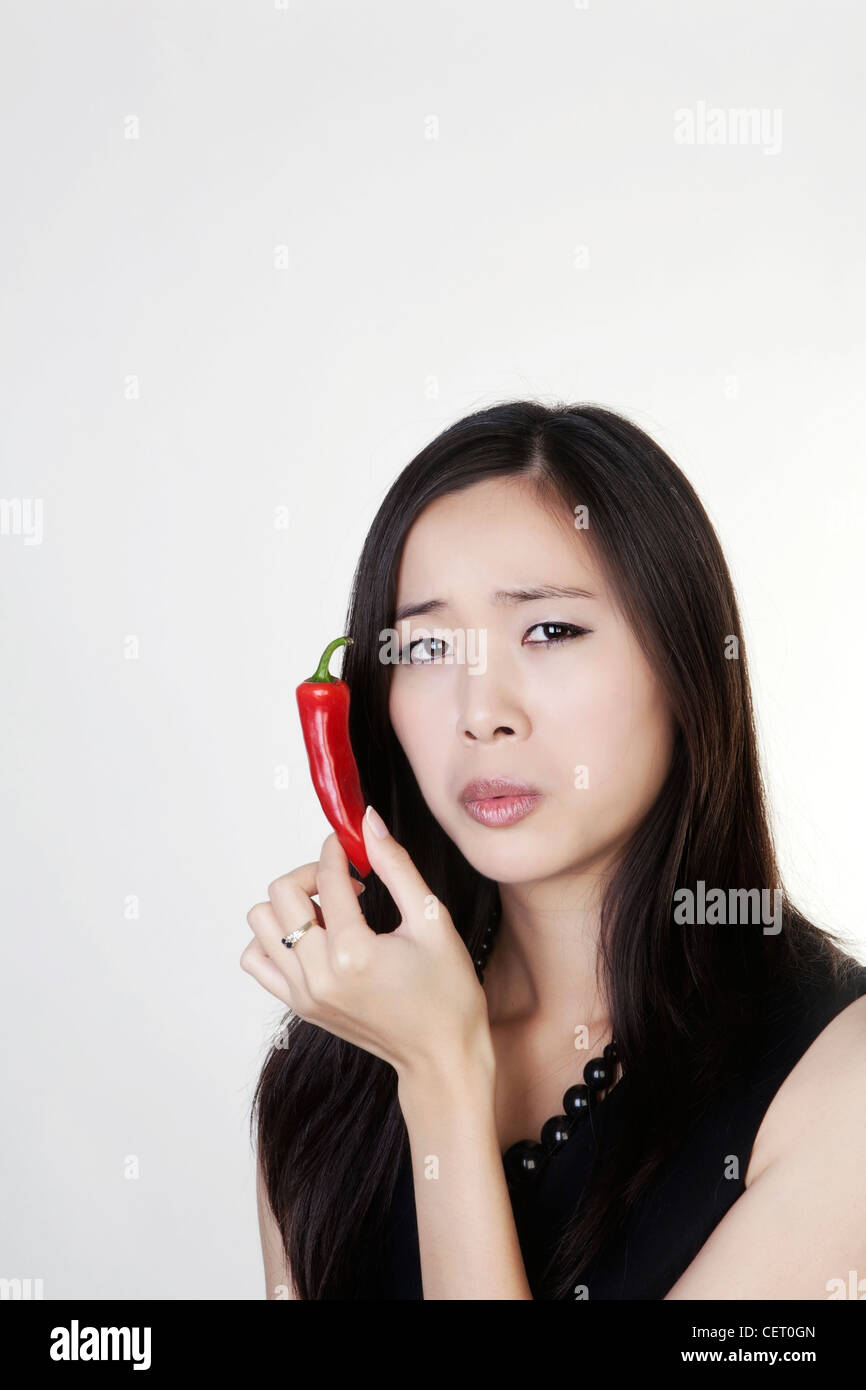 picture of lovely woman with a hot fresh chilli Stock Photo - Alamy