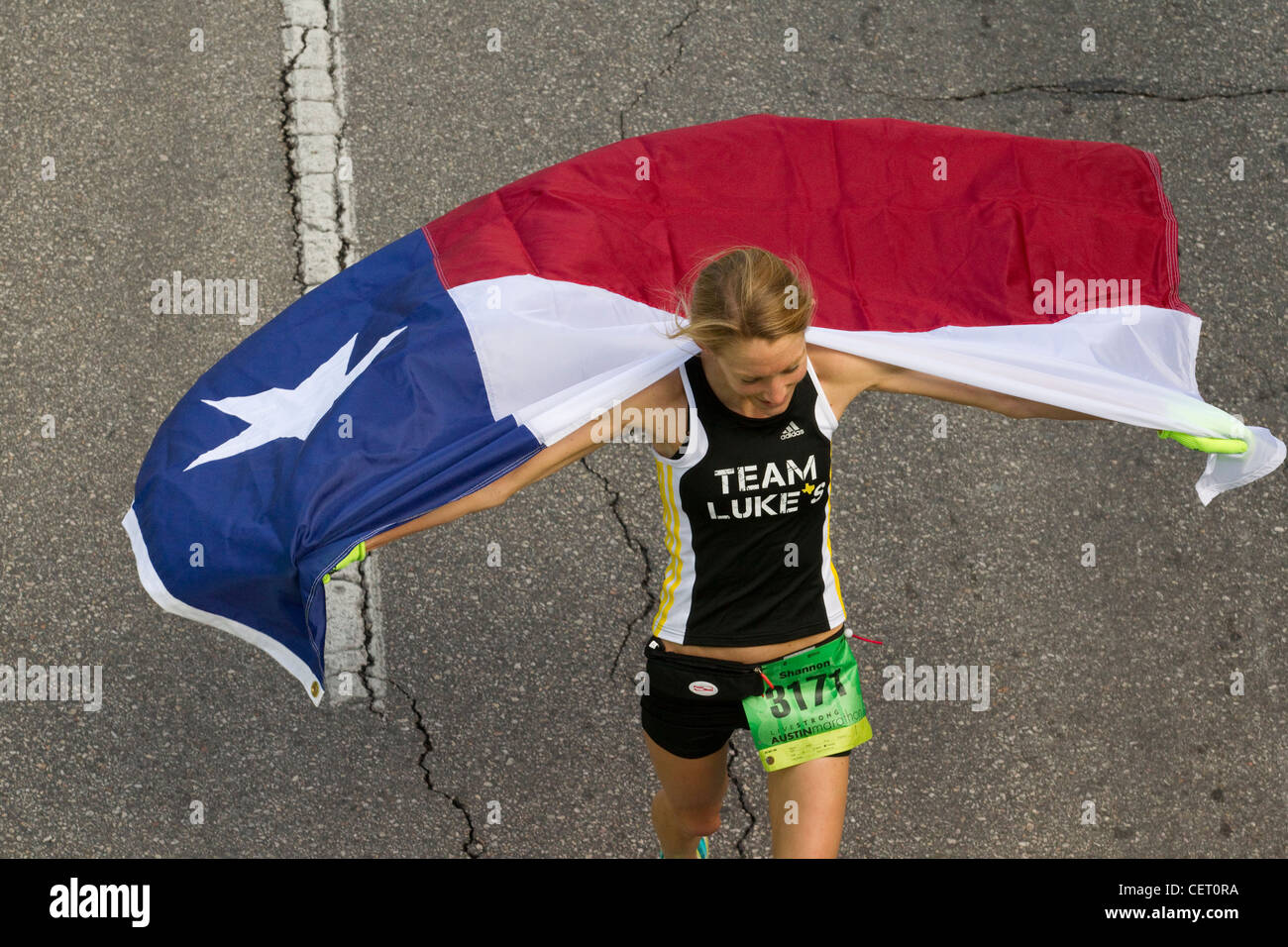 White female celebrates marathon victory with Texas flag after first ...