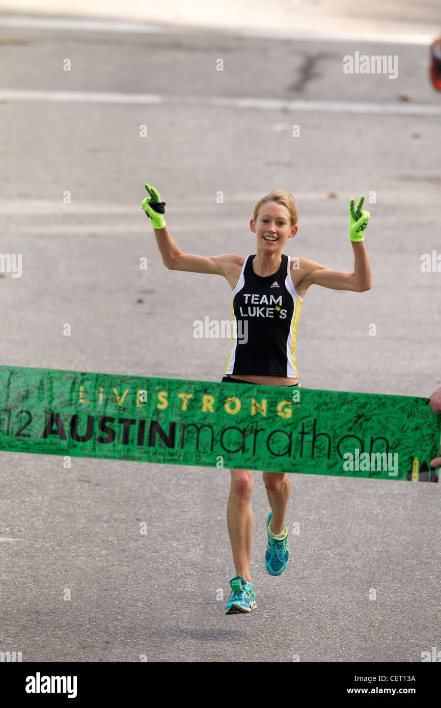 First woman finisher flashes V for victory sign as she crosses finish ...