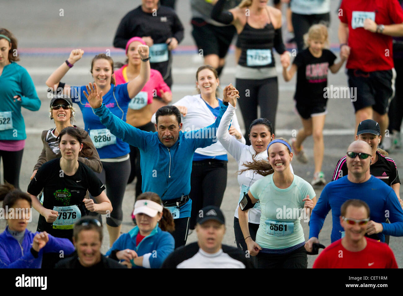 group of happy athletes complete marathon race through streets of ...