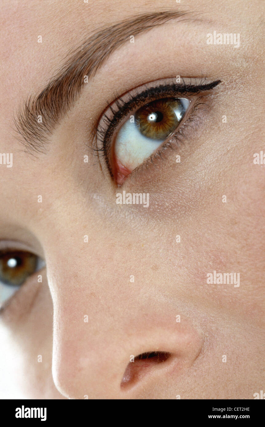 A close up image of female's face, wearing bold black eyeliner on her ...