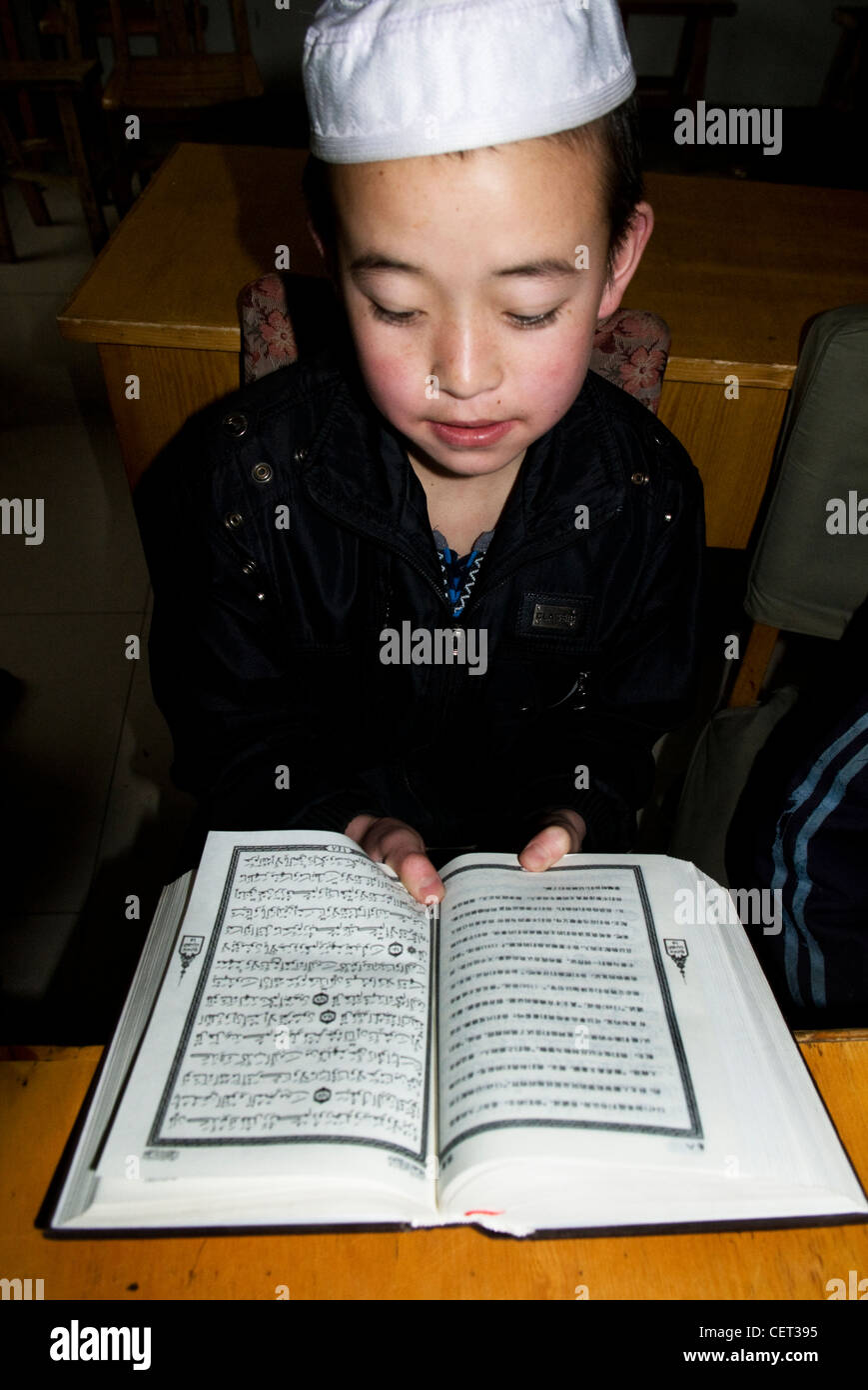 A Hui Muslim boy studying the Quran Stock Photo - Alamy