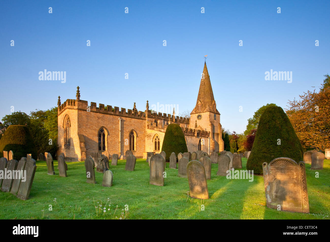 First light over the parish church of St Anne in Baslow. The clock face ...