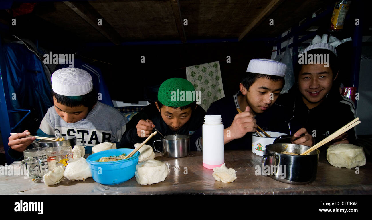 Hui Muslim children eating breakfast in their dorm room located in the ...