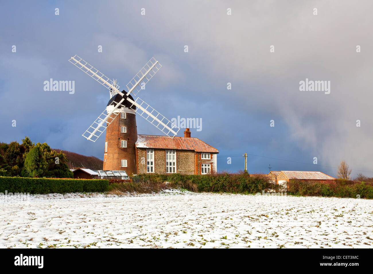 Snow covering the ground by Weybourne Windmill, a grade ll listed ...