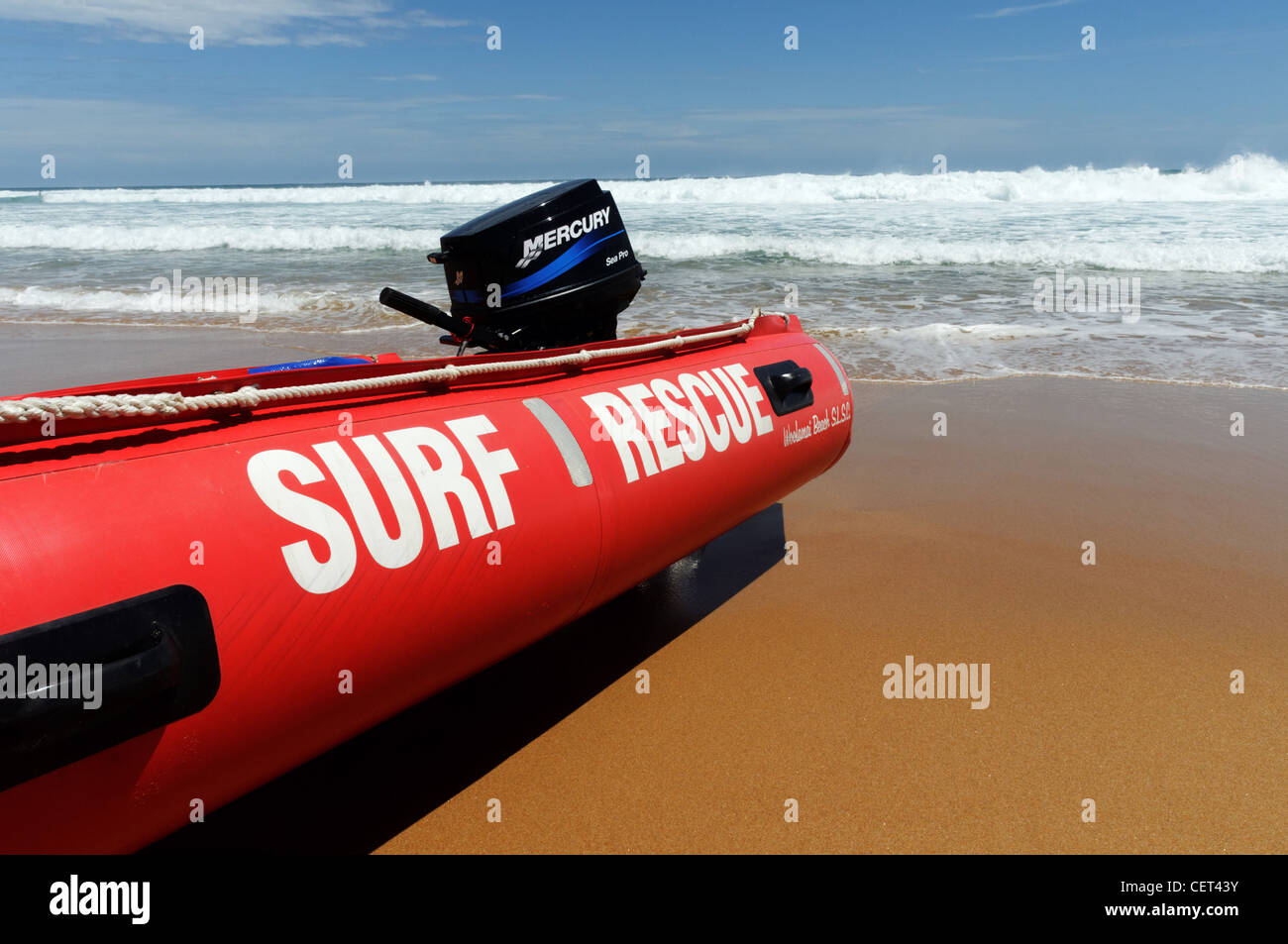 A red surf rescue zodiac pulled up on a beach Stock Photo - Alamy