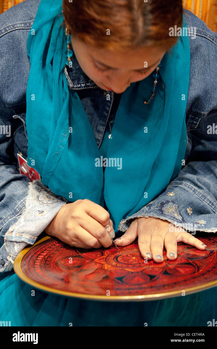 Woman carving a design into a plate in Islamabad, Pakistan Stock Photo ...