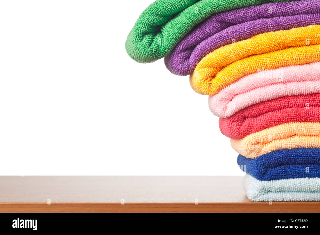 Stack of colorful microfiber towels toppling against white background ...