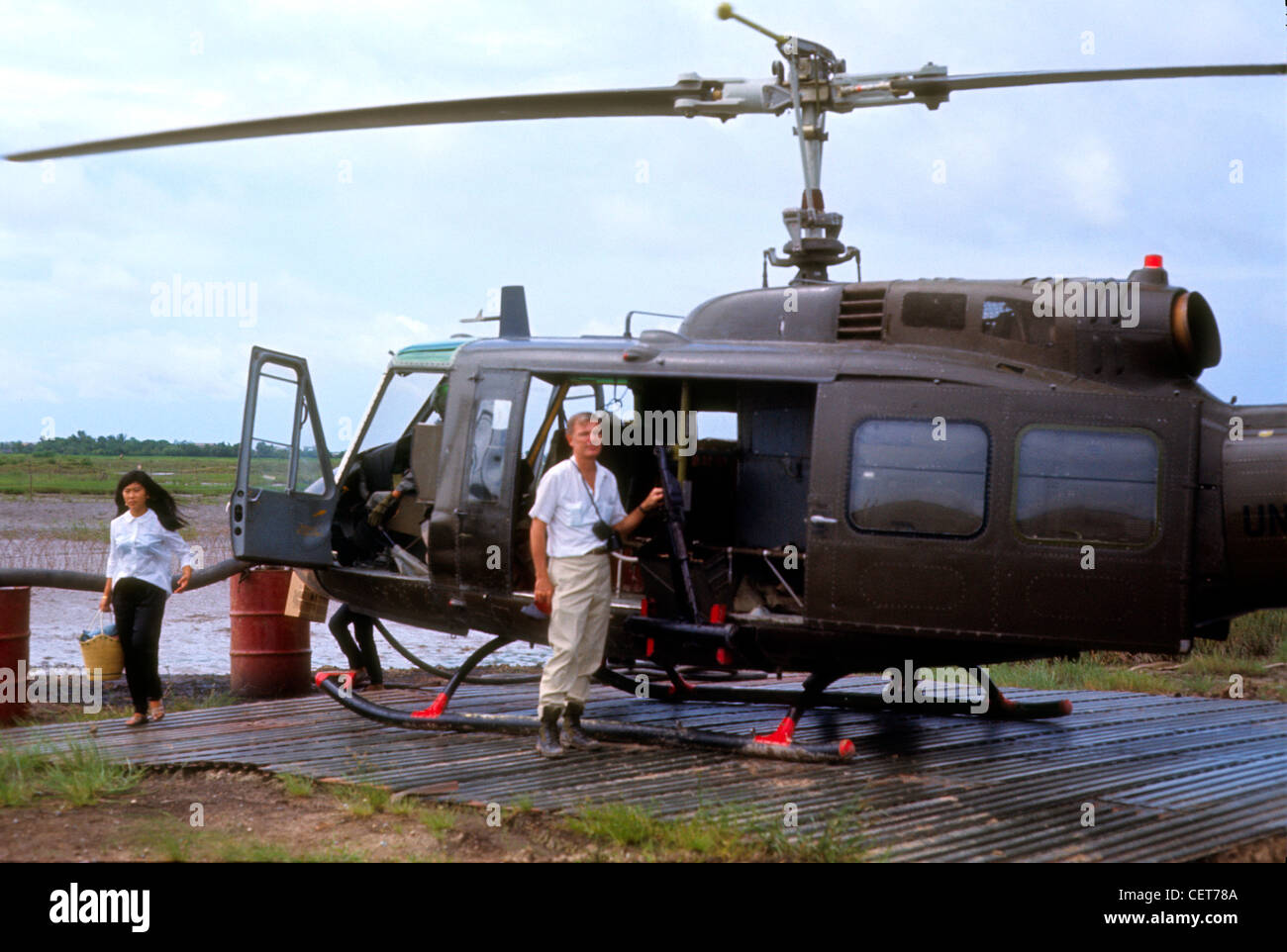 American standing next to unmarked helicopter during the Vietnam War ...