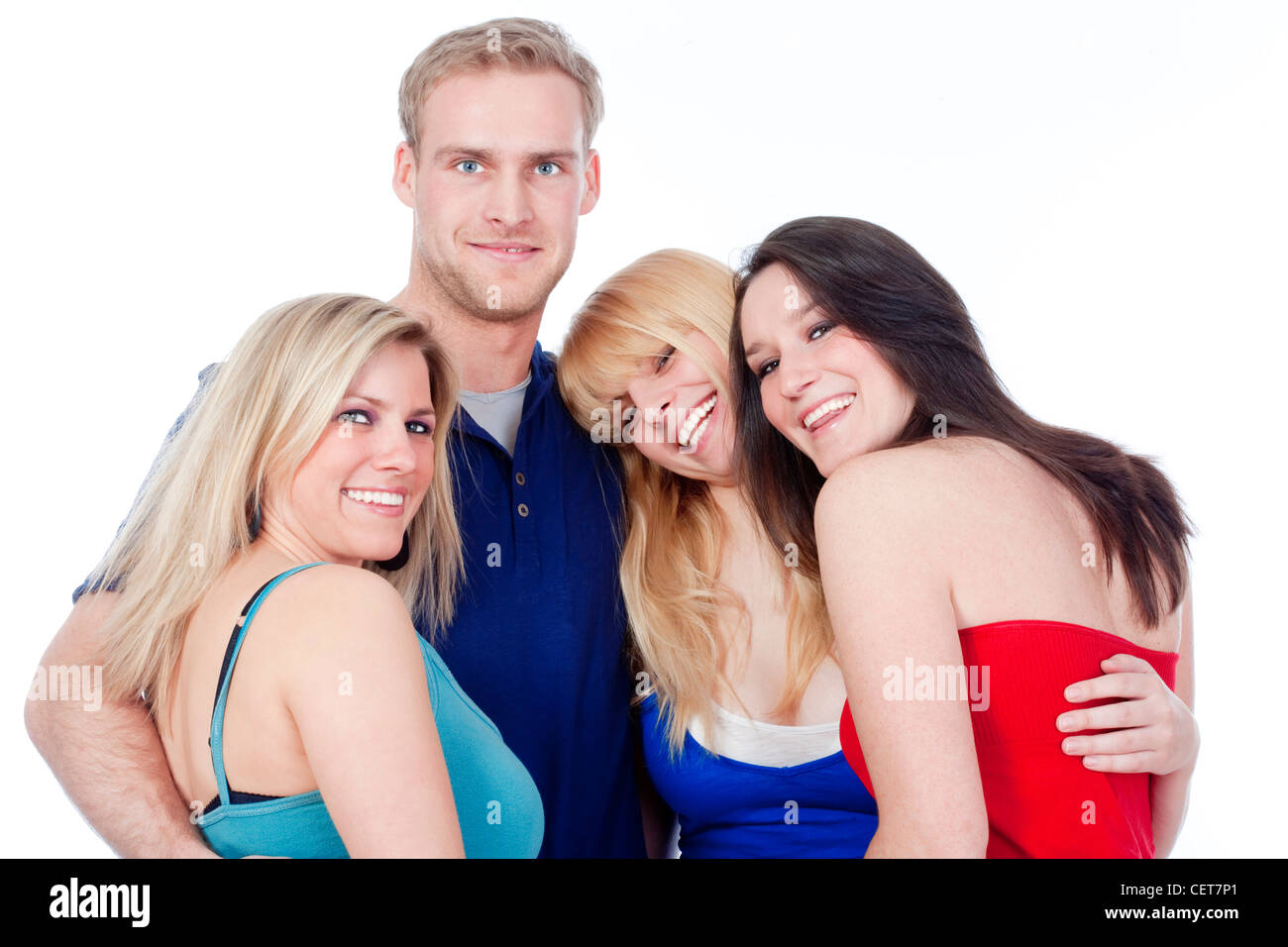 four young friends embracing, smiling, looking at camera - isolated on ...