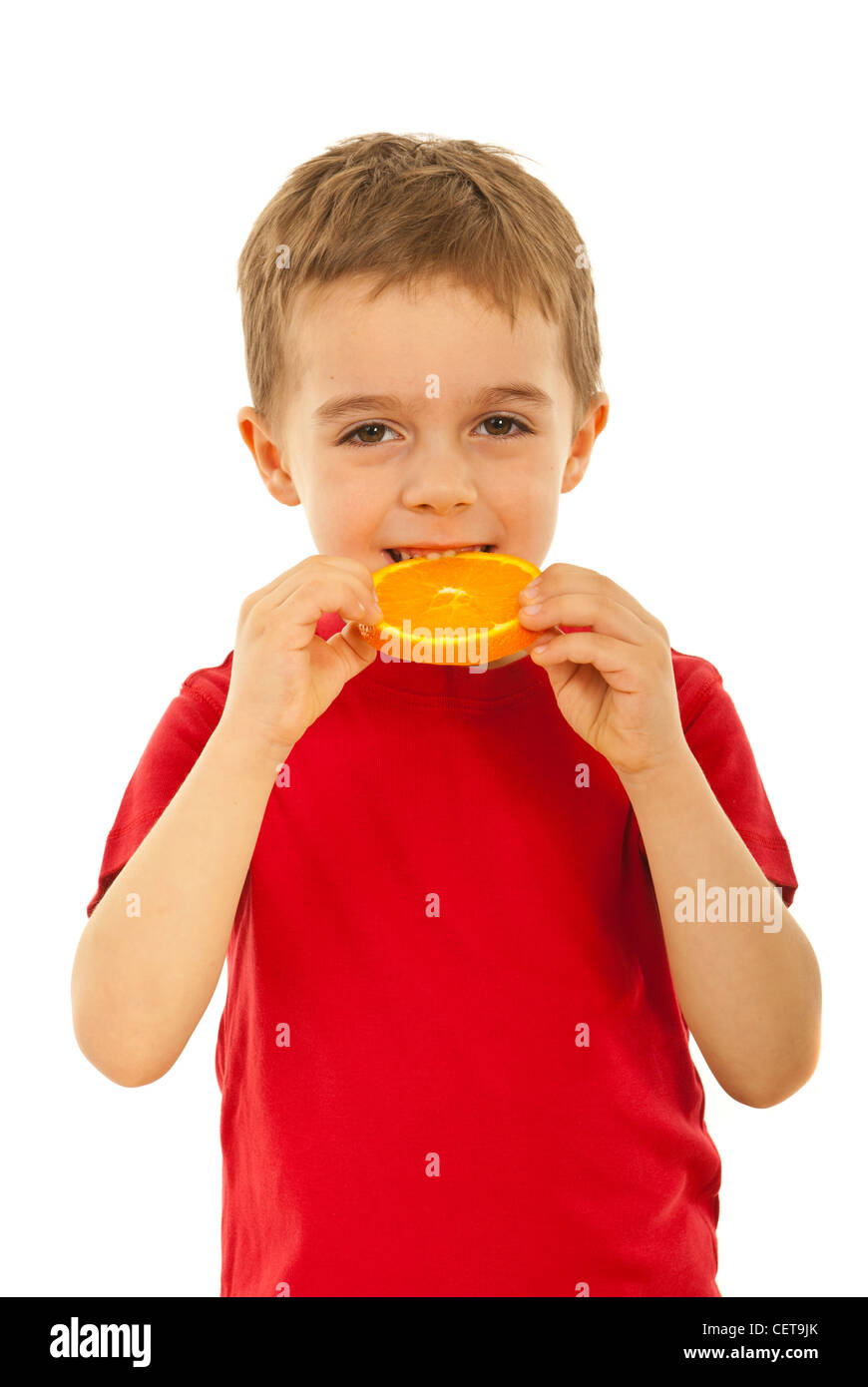 Kid boy biting a slice orange isolated on white background Stock Photo ...